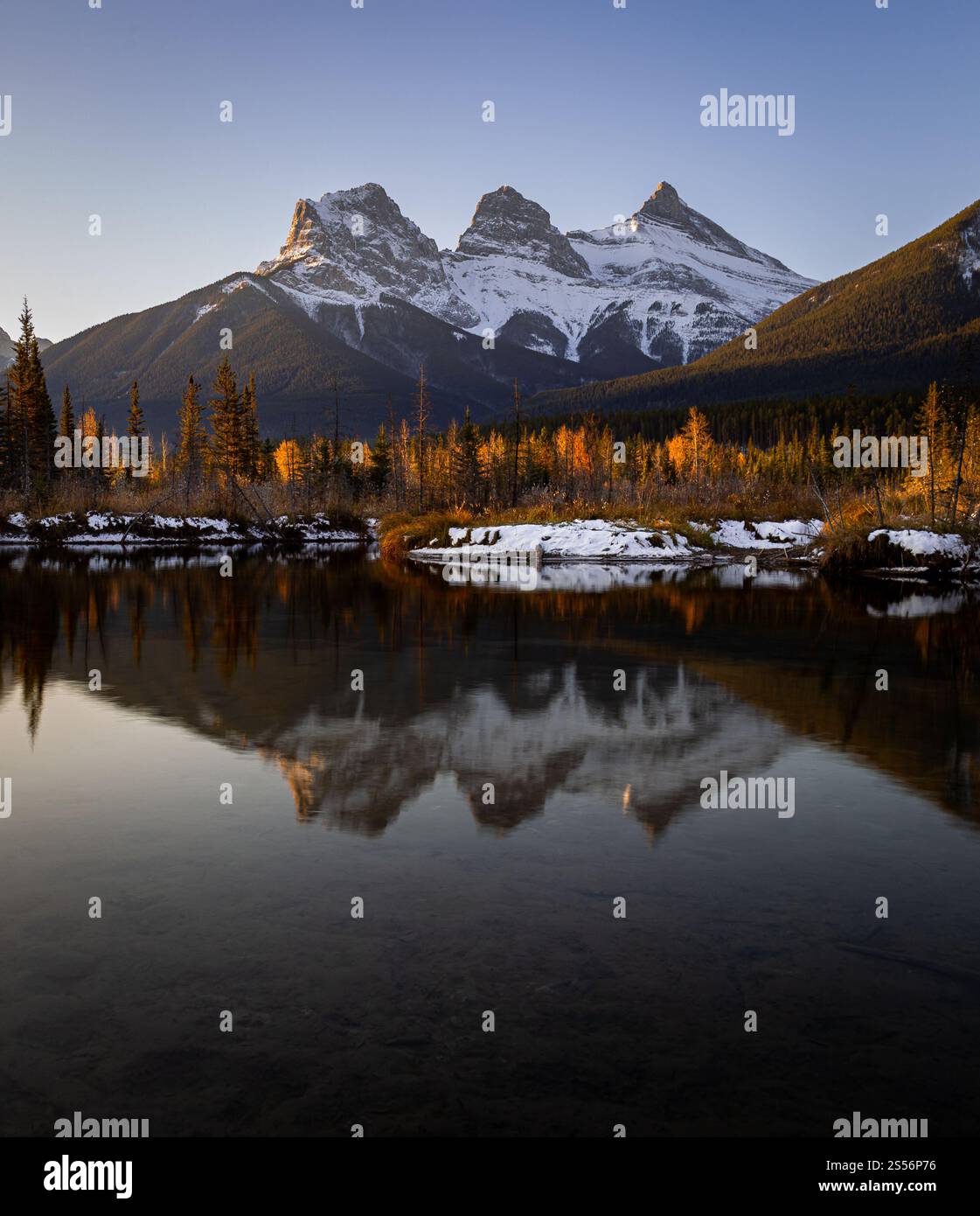 The Three Sisters in Canmore reflecting during a sunrise at Policeman's ...