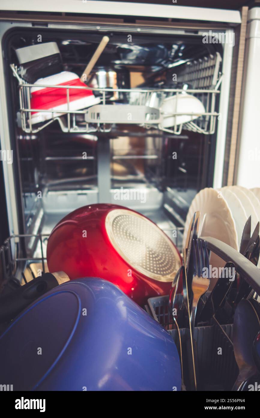 Open dishwasher in a kitchen. Closeup view. Open dishwasher in a ...