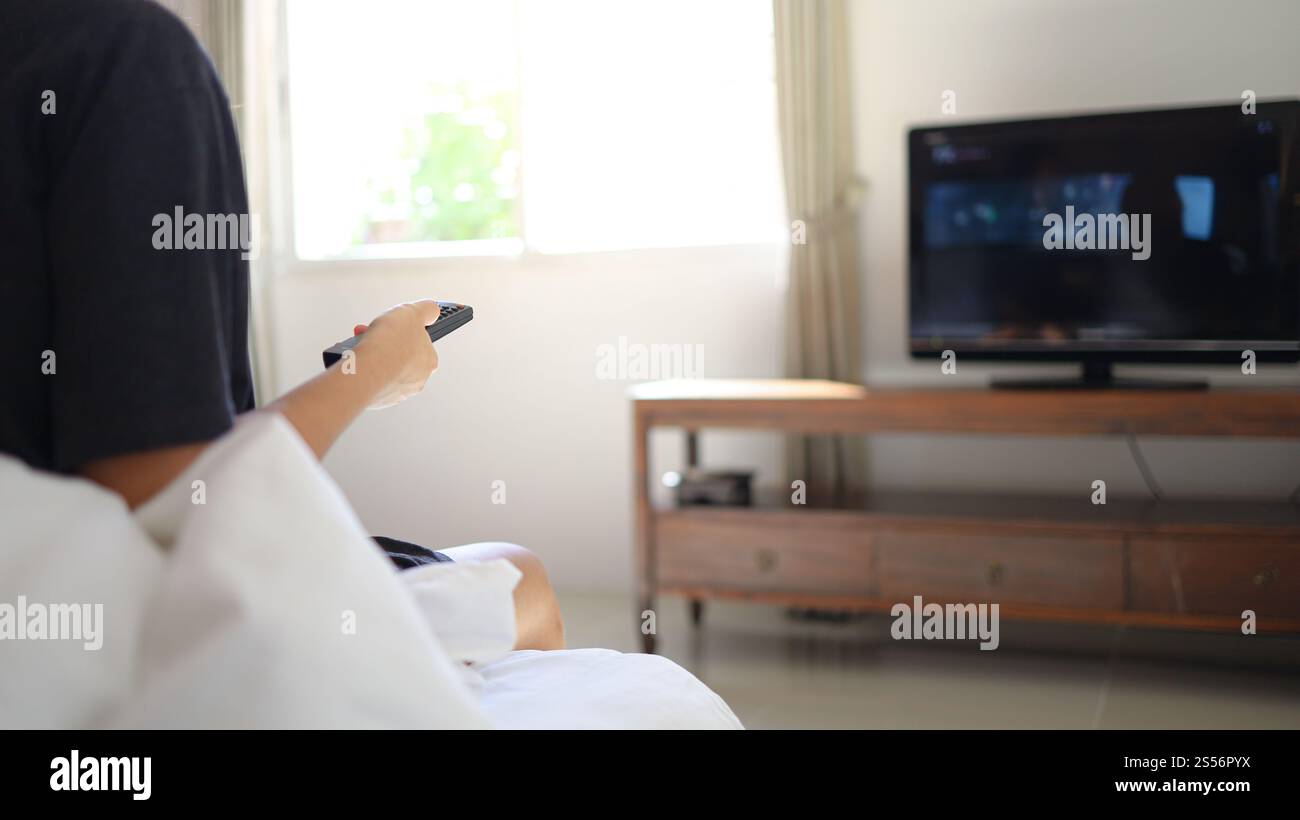 Watching smart TV and using remote controller Hand holding television ...