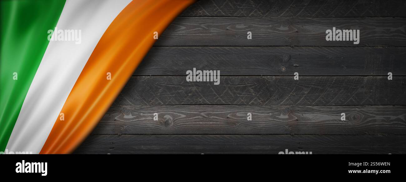 Ireland flag on black wood wall. Horizontal panoramic banner. Irish ...