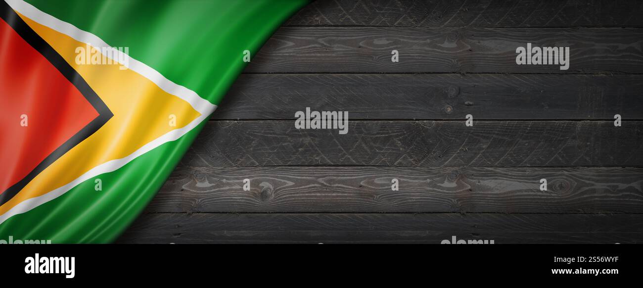 Guyana flag on black wood wall. Horizontal panoramic banner. Guyanese ...