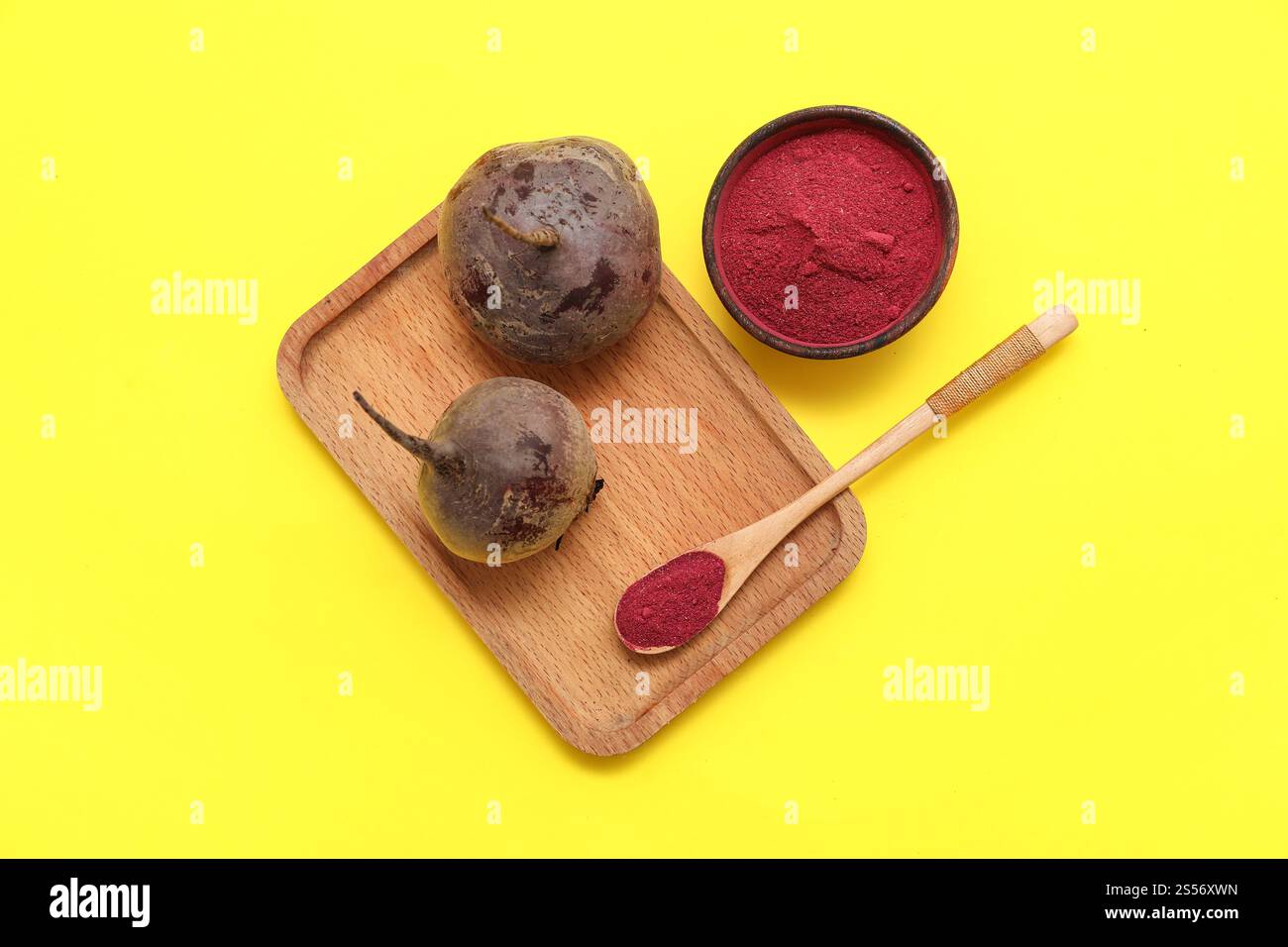 Bowl with beet powder on yellow background Stock Photo - Alamy
