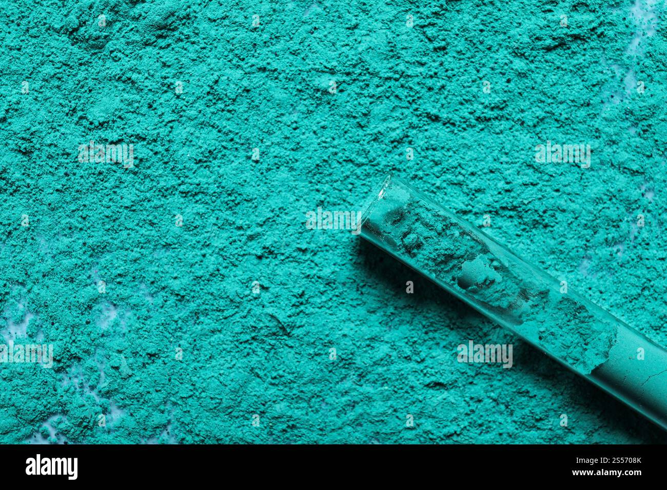 Tube on turquoise powder pigment, closeup Stock Photo - Alamy
