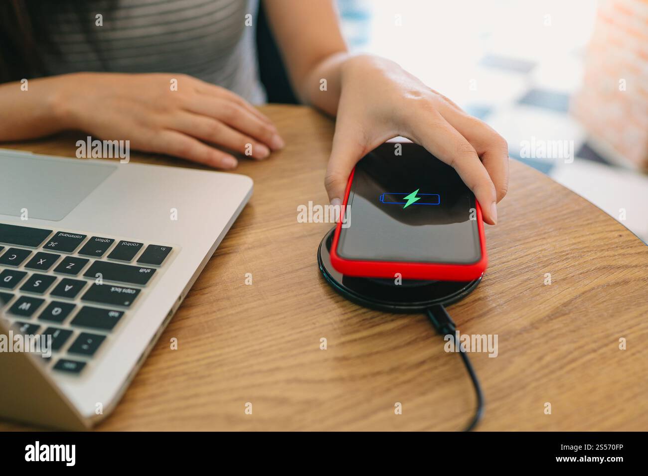 Charging mobile phone battery with wireless device in the table ...