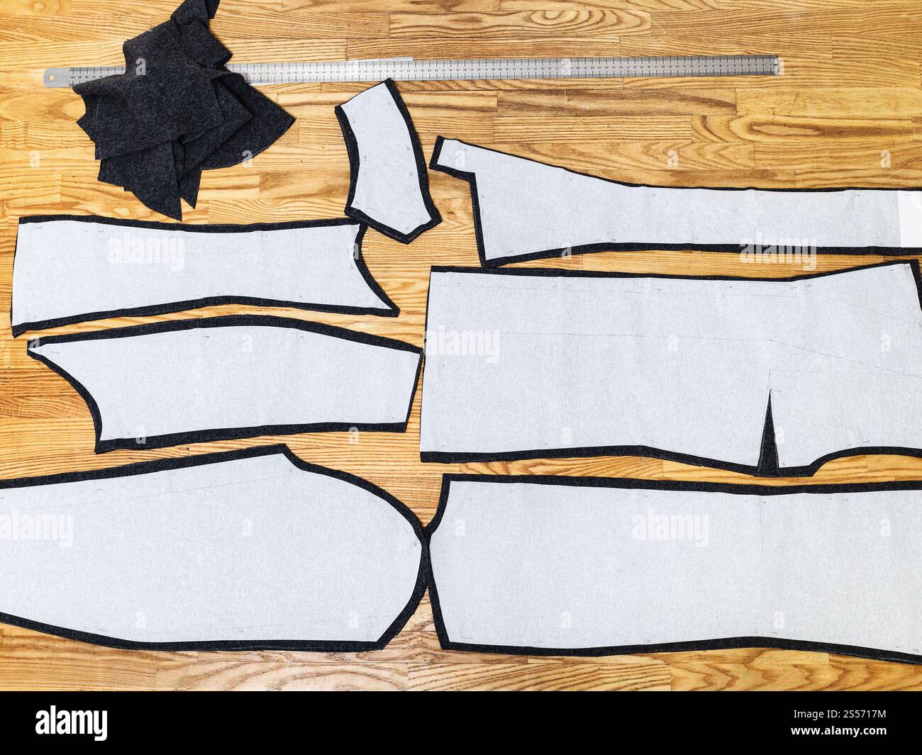 cut dress details with paper layouts of sewing patterns and steel ruler ...