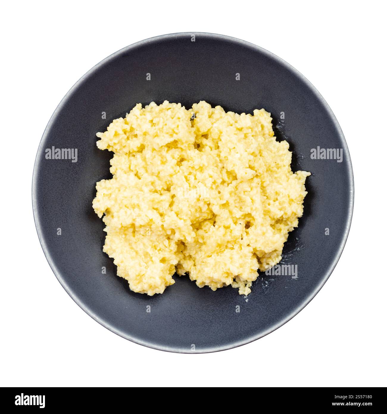 top view of boiled porridge from proso millet groats in gray bowl ...