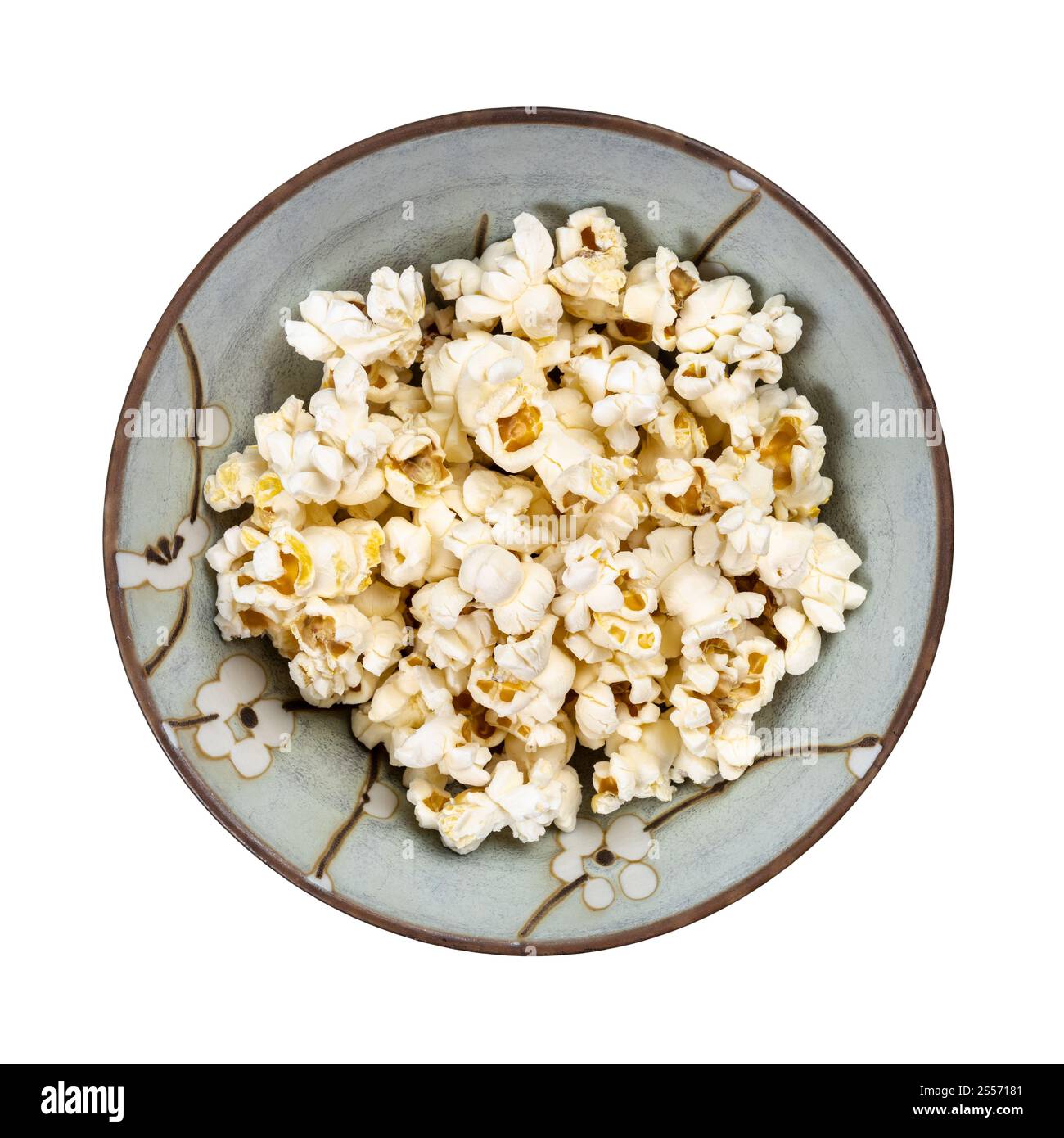 top view of puffed popcorn in ceramic bowl isolated on white background ...