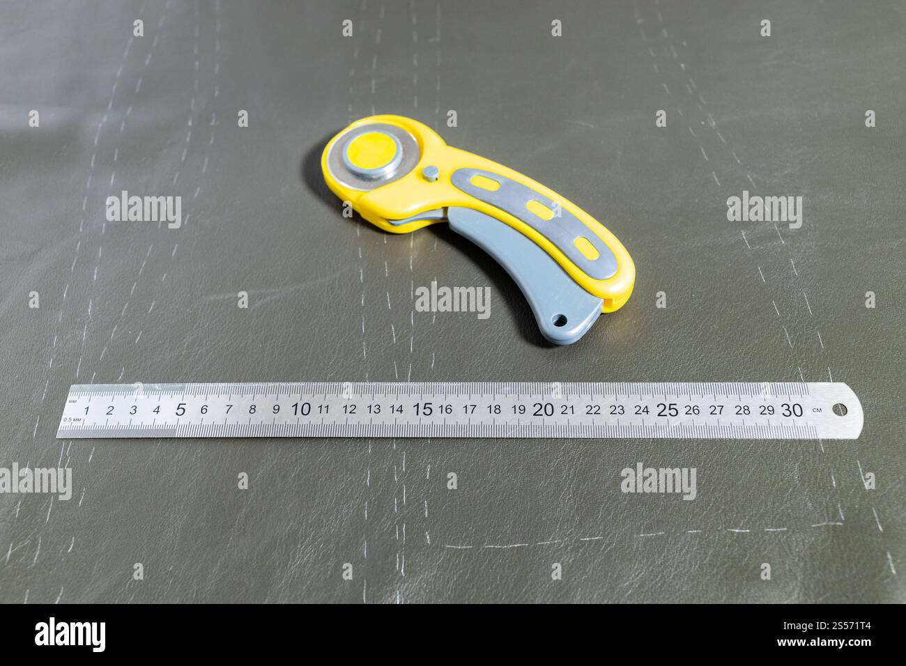 steel ruler and rotary cutter on leather with drawn pattern Stock Photo ...