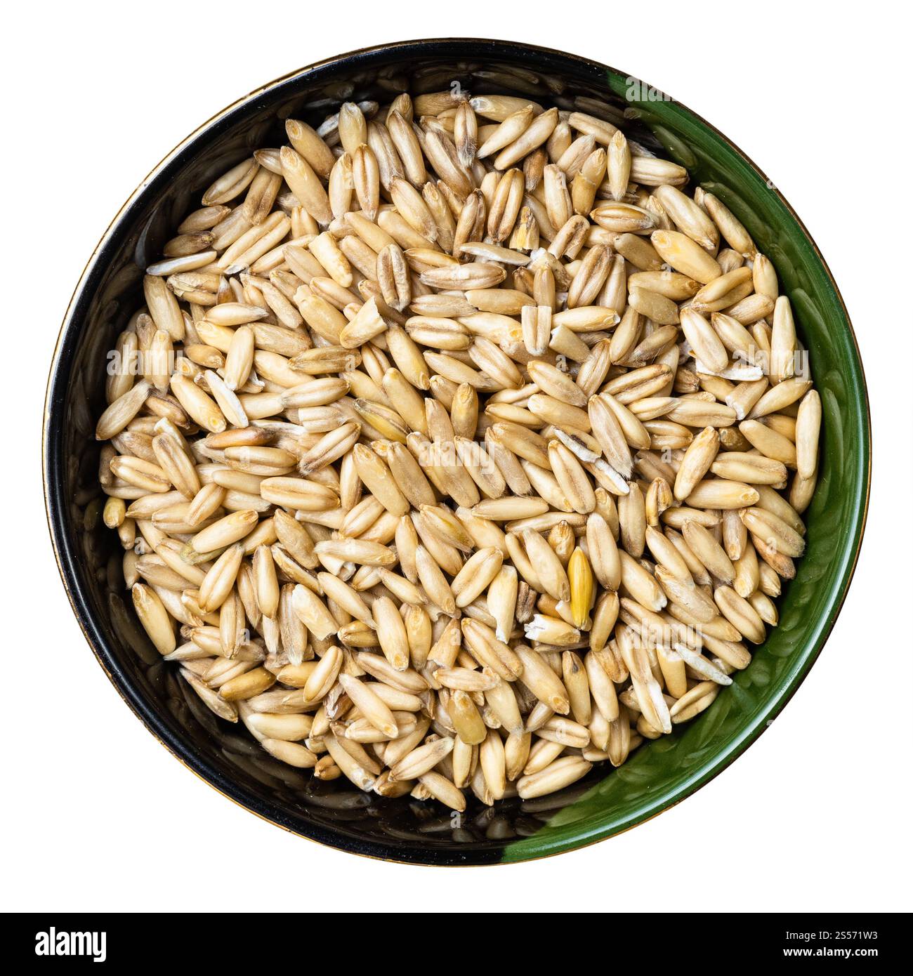 top view of unpolished oat grains in round bowl isolated on white ...