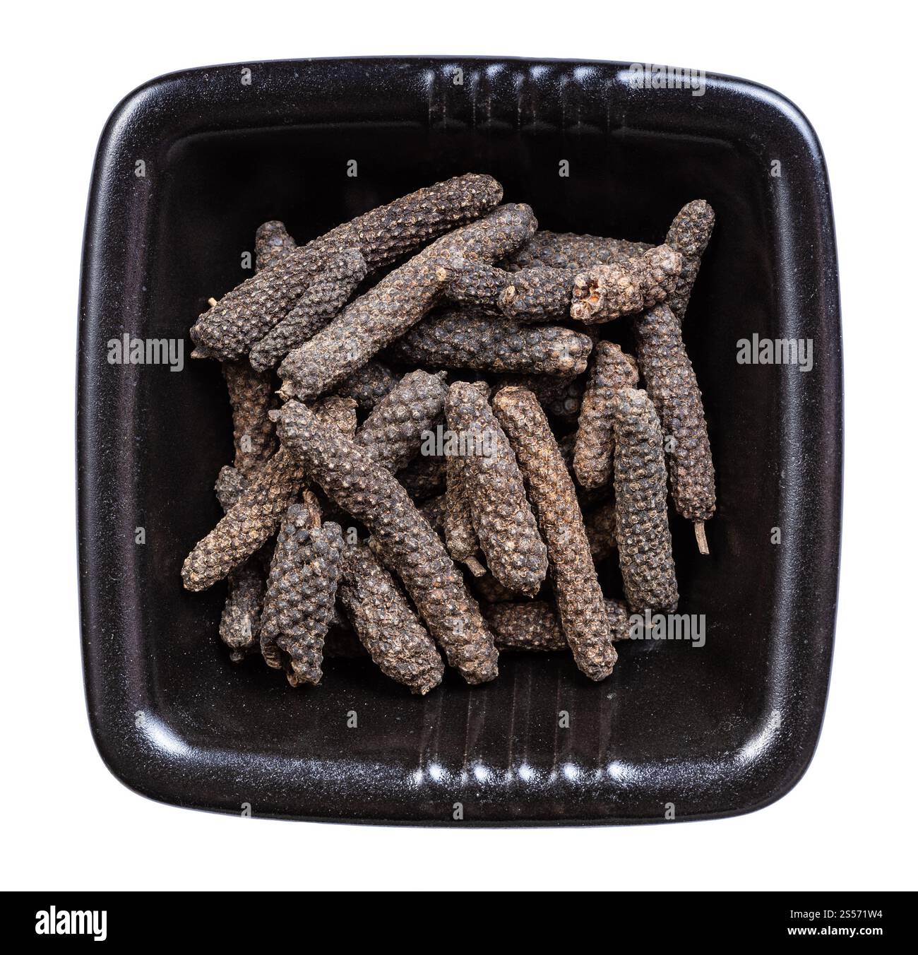 top view of java long pepper in black bowl isolated on white background ...