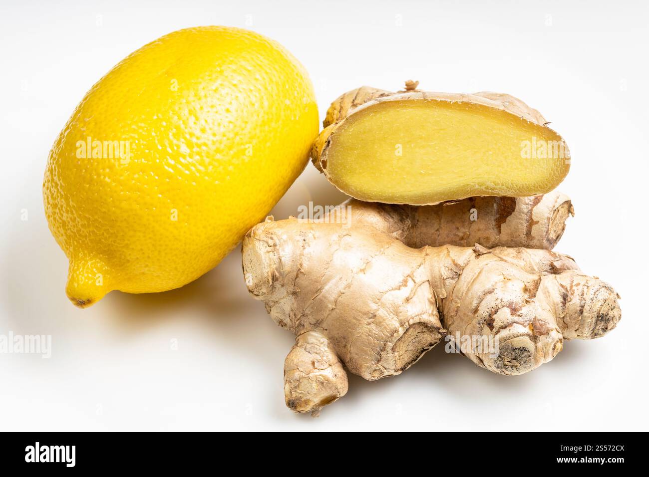 natural fresh whole and cut ginger roots and whole lemon fruit on gray ...