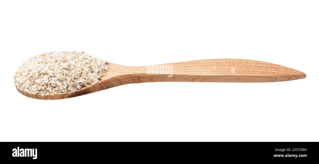 side view of psyllium husk in wooden spoon isolated on white background ...