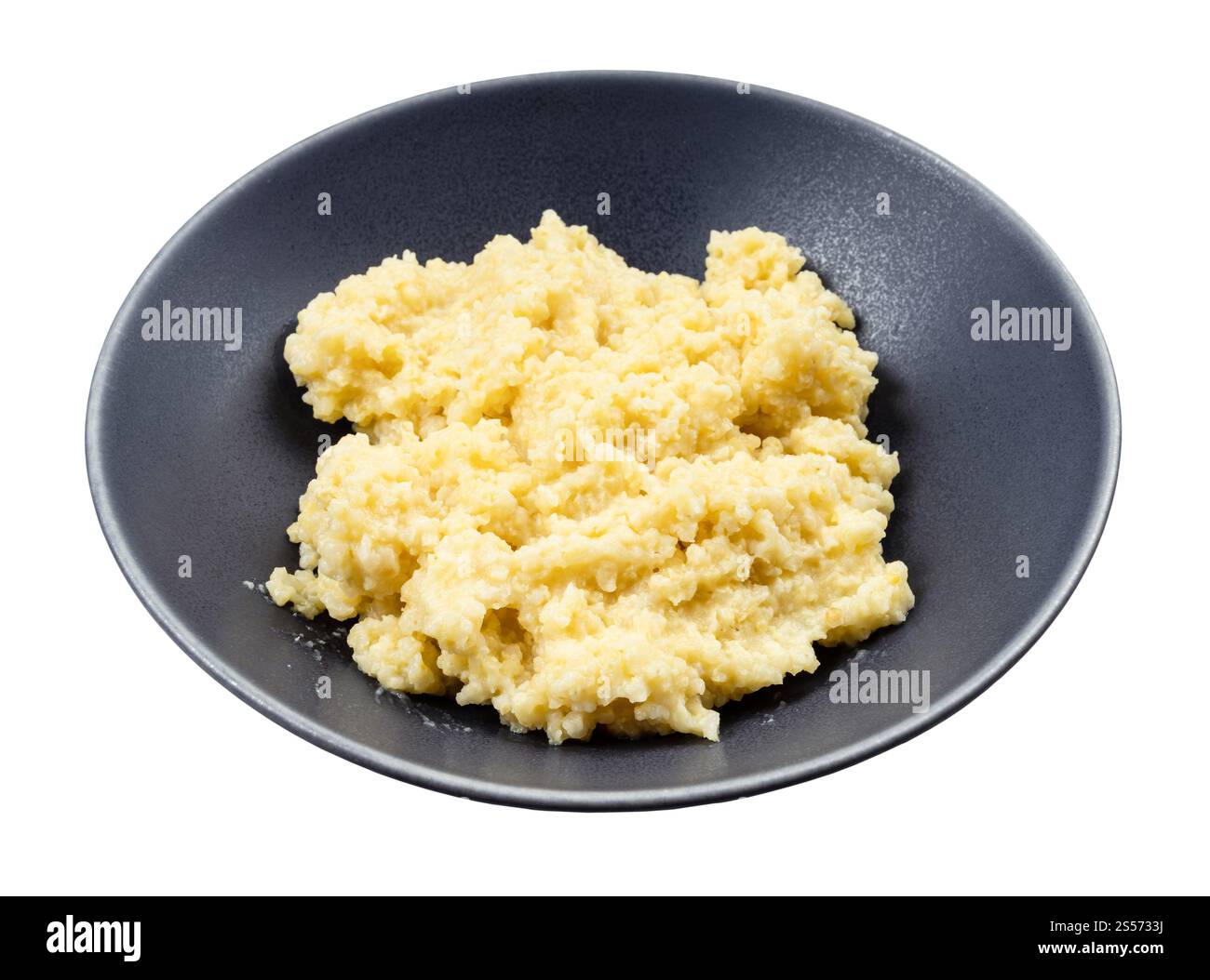 boiled porridge from proso millet groats in gray bowl isolated on white ...