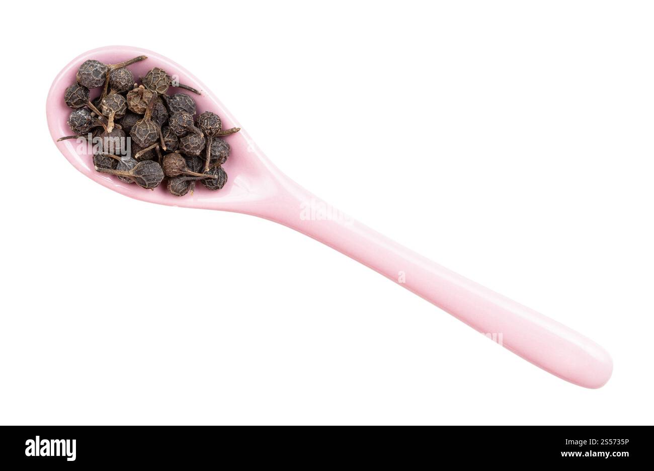 top view of tailed pepper (cubeb) in ceramic spoon isolated on white ...