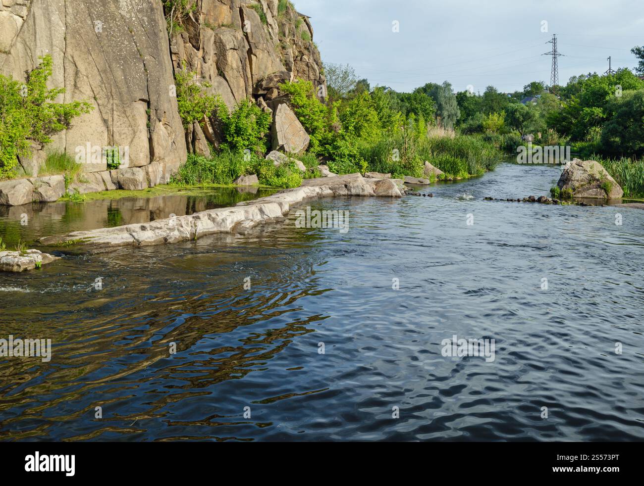 Small picturesque pond on river near rock. Sunny, summer day on Ros ...