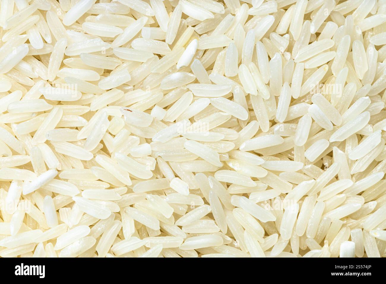 food background - uncooked polished long-grain jasmine rice Stock Photo ...