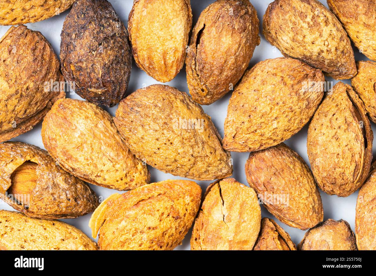 food background - many cracked almond drupes Stock Photo - Alamy