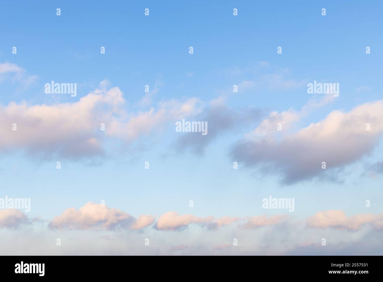chain of fluffy clouds in blue sunset sky in spring evening Stock Photo ...
