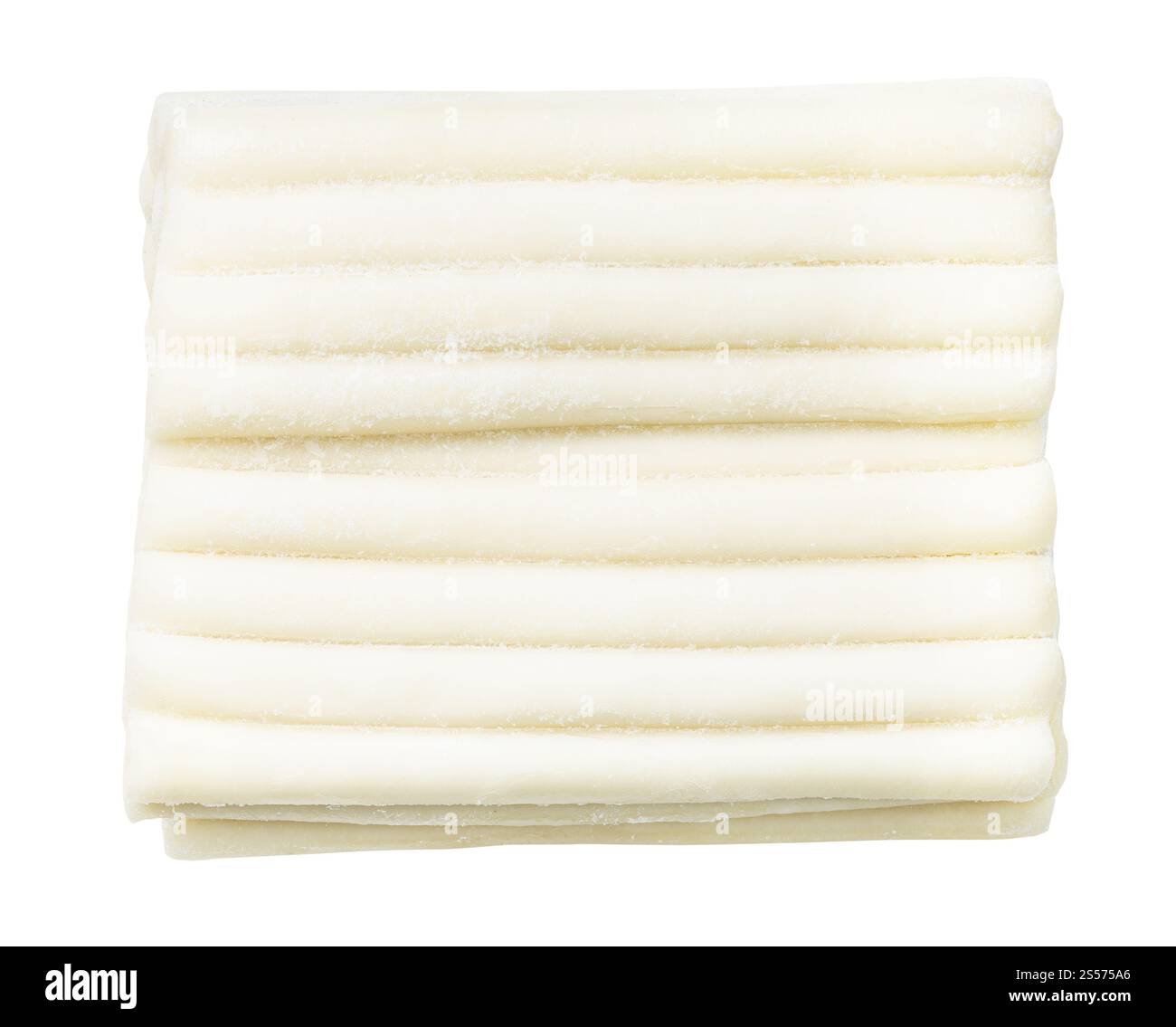 top view of raw frozen tteokbokki (korean rice cakes) isolated on white ...