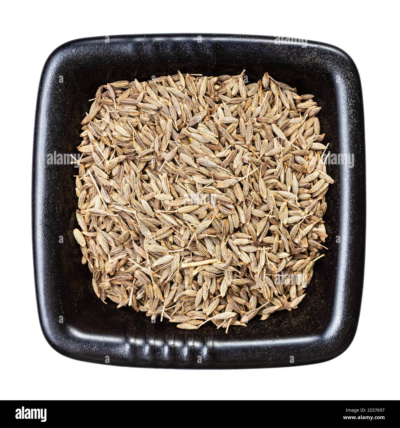 top view of cumin (cuminum cyminum) seeds in black bowl isolated on ...