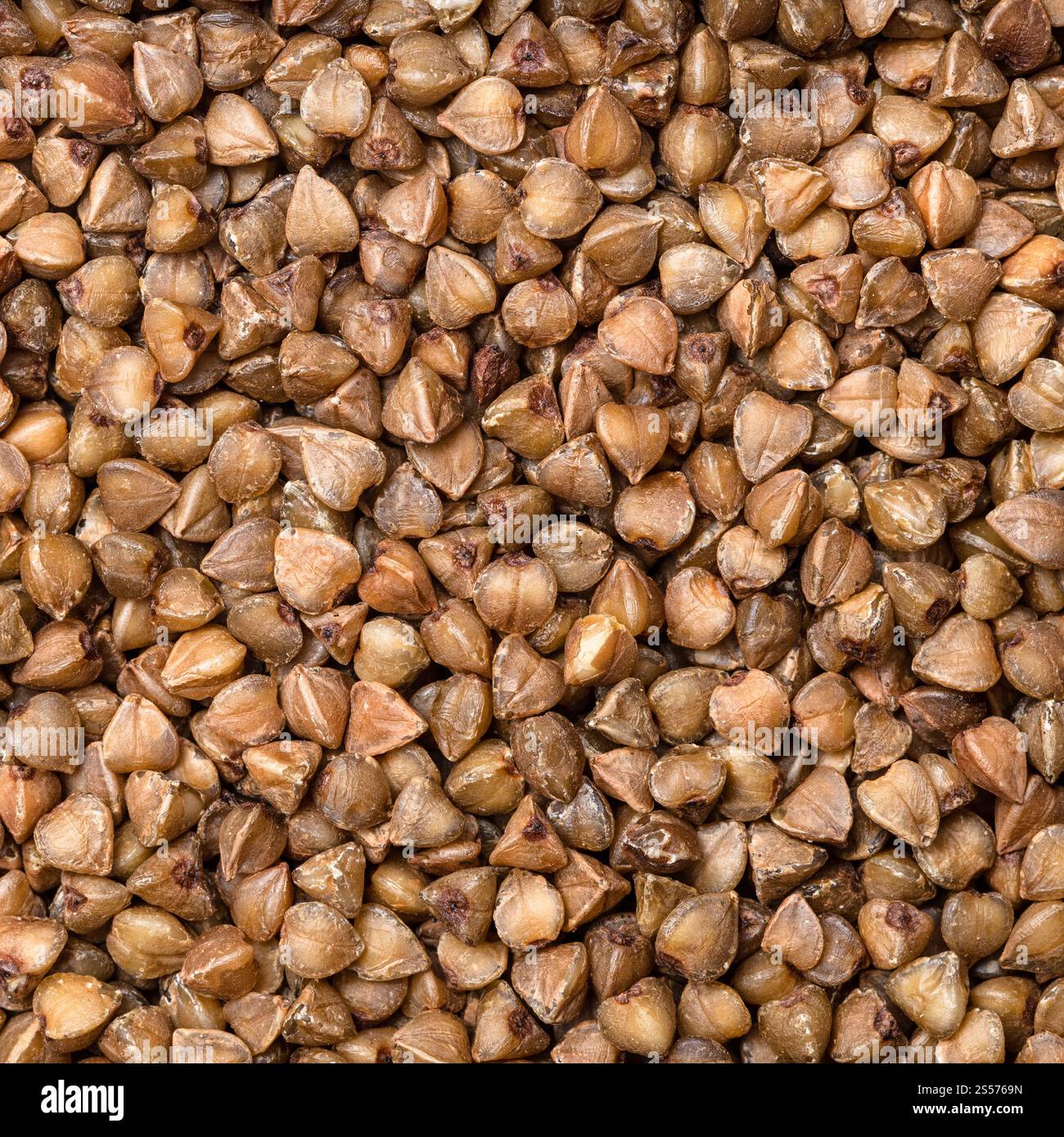 square food background - roasted buckwheat grains close up Stock Photo ...