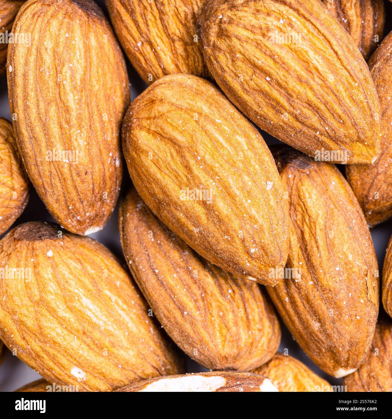 square food background - raw almond seeds close up Stock Photo - Alamy