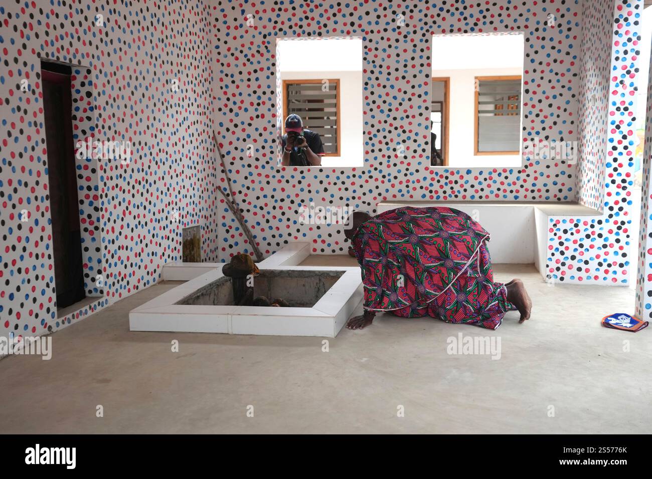 A voodoo priest prays inside a shrine during the annual Voodoo Festival ...