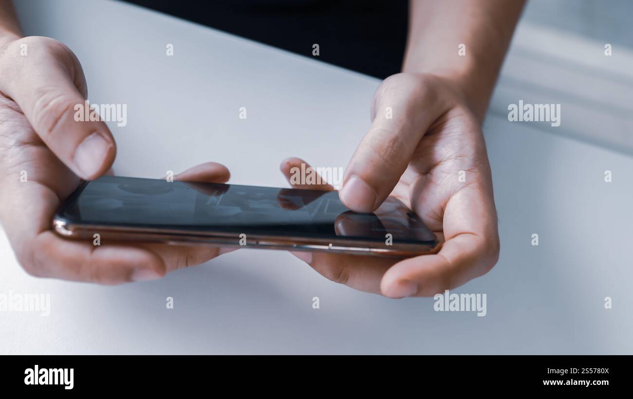 Man playing game on mobile phone. gamer boy playing video games holding ...