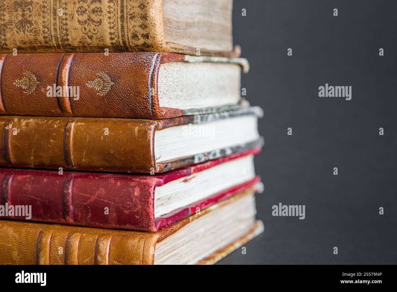 Stack of old books isolated on dark background. Stack of old books on ...
