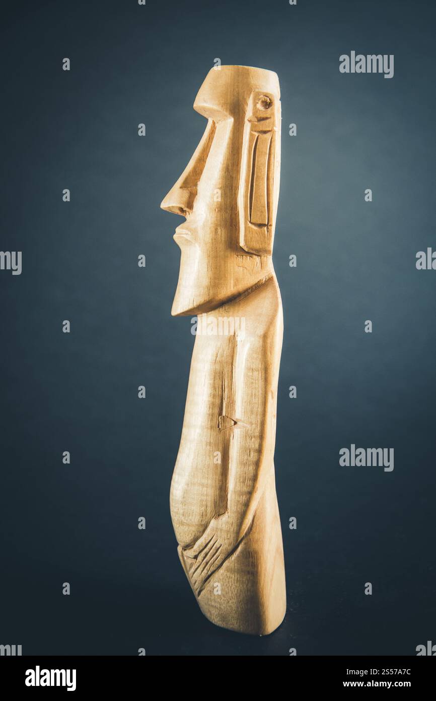 Traditional wooden statue of a moai from Easter Island. Dark background ...
