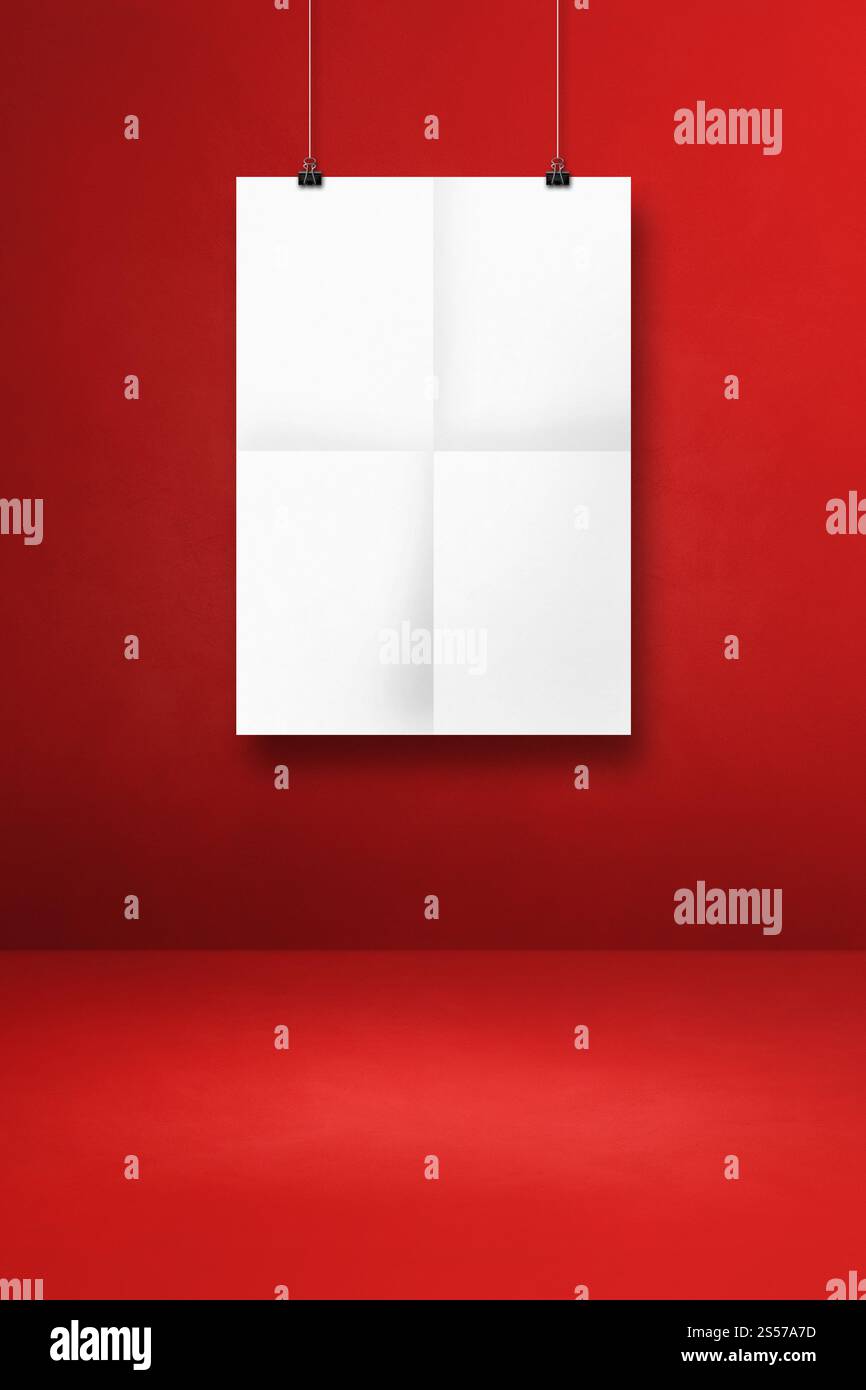 White folded poster hanging on a red wall with clips. Blank mockup ...