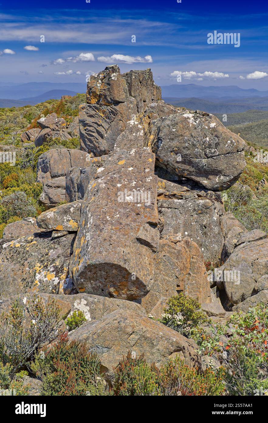Jumble of dolerite rock and blue sky landscape from summit of peak at ...