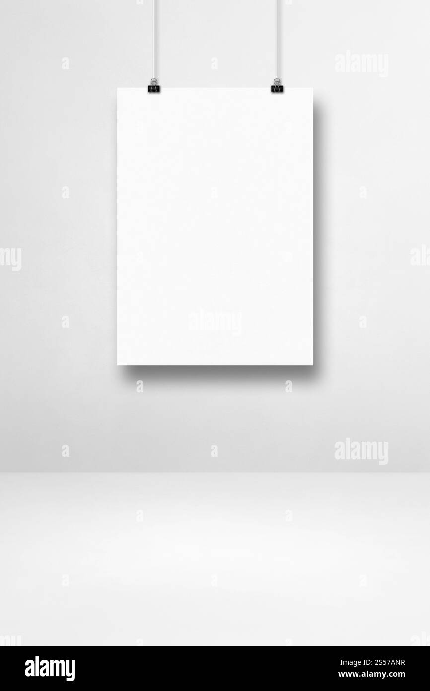 White poster hanging on a clean wall with clips. Blank mockup template ...