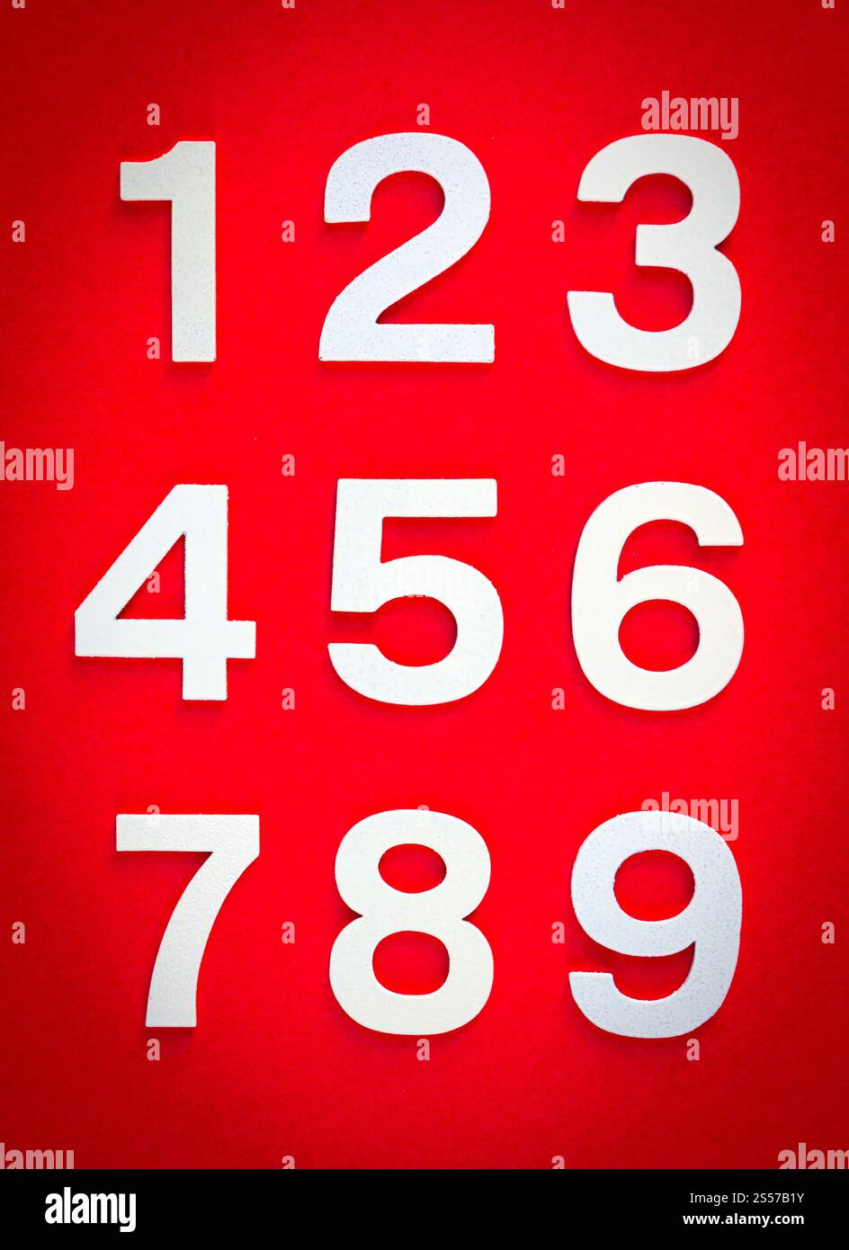 Mathematics background made with solid numbers from 1 to 9 on a red ...