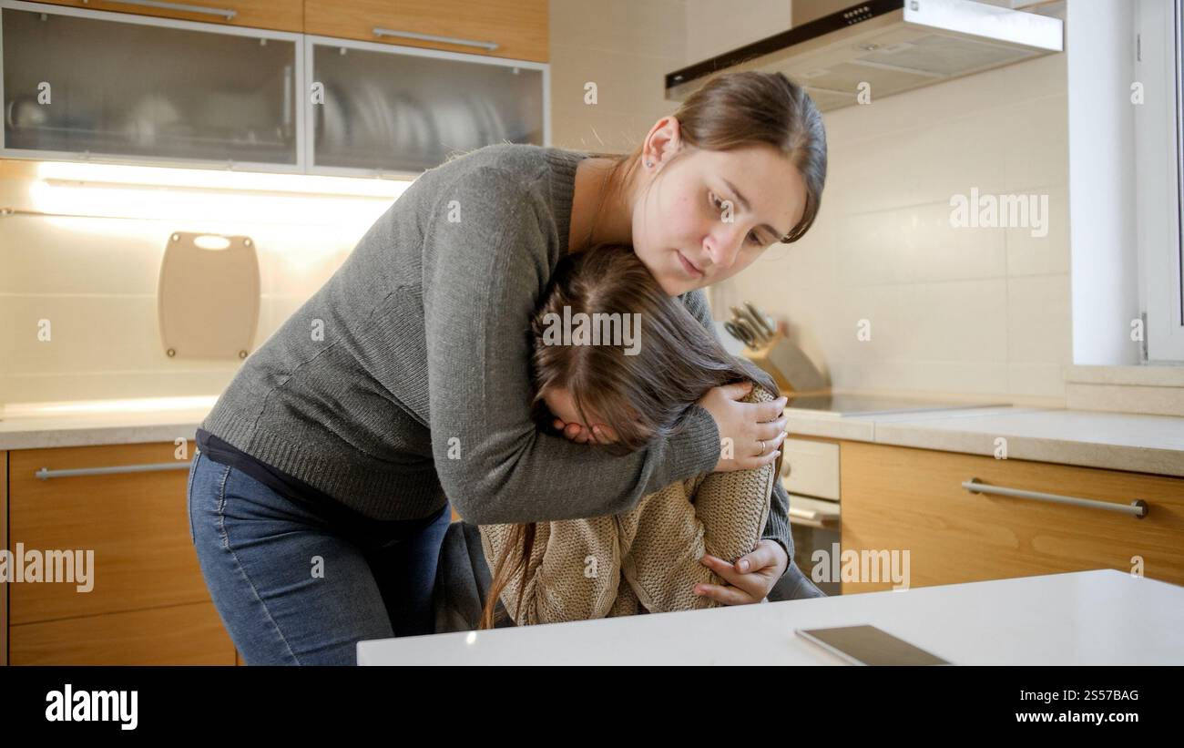 Teenage girl crying after receiving negative message or abuse in social ...