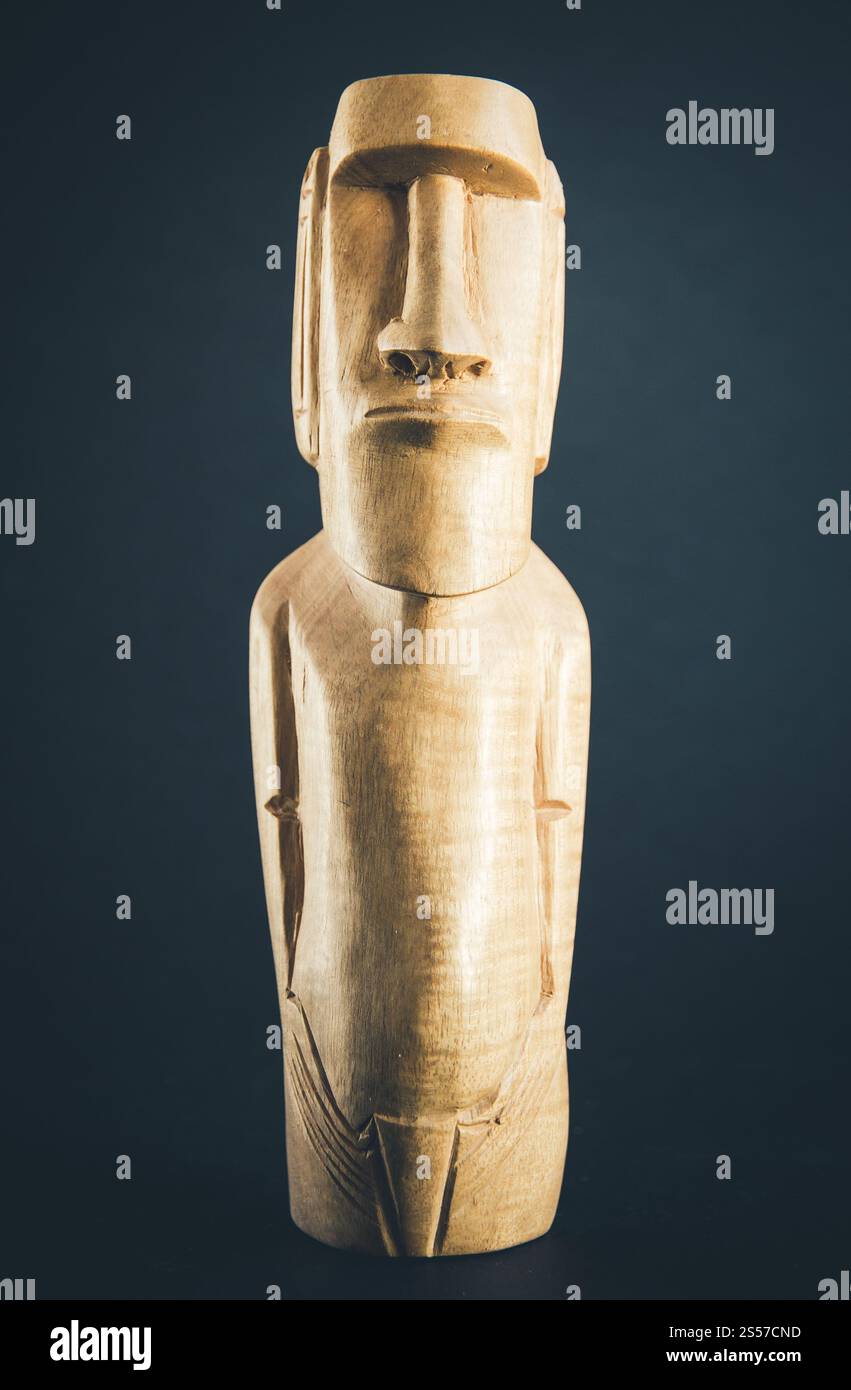Traditional wooden statue of a moai from Easter Island. Dark background ...
