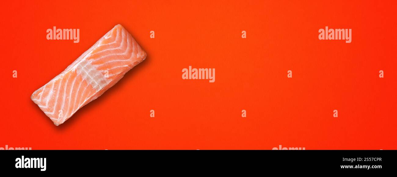 Salmon steak isolated on red background. Top view. Horizontal banner ...