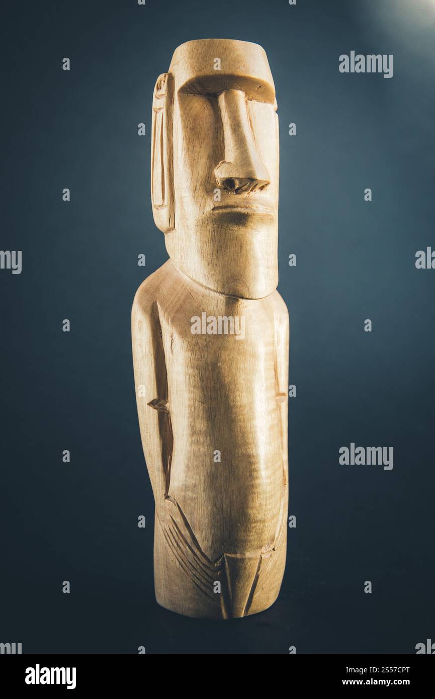 Traditional wooden statue of a moai from Easter Island. Dark background ...