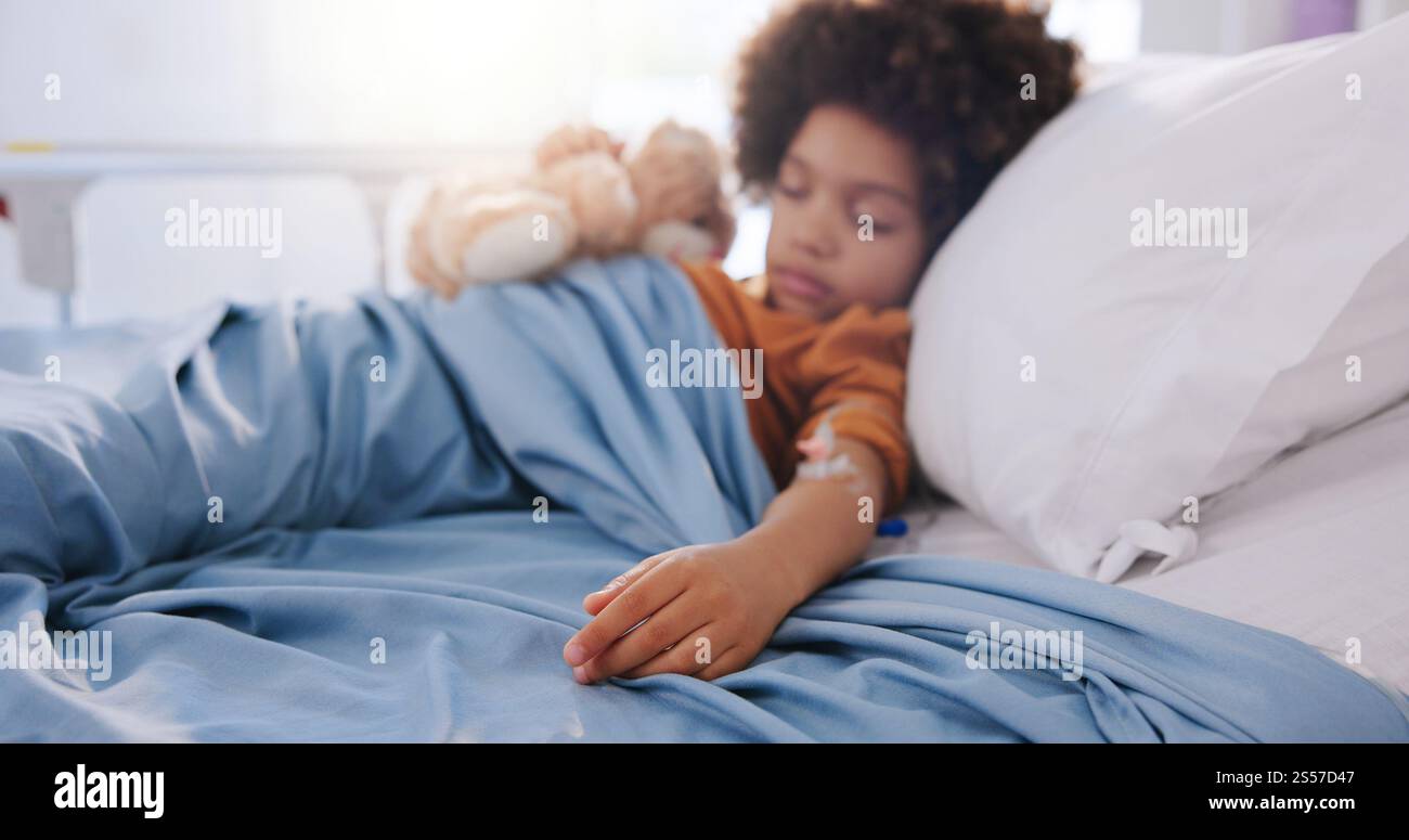 Kid sleeping, hospital bed and sick teddy bear for recovery, immune ...