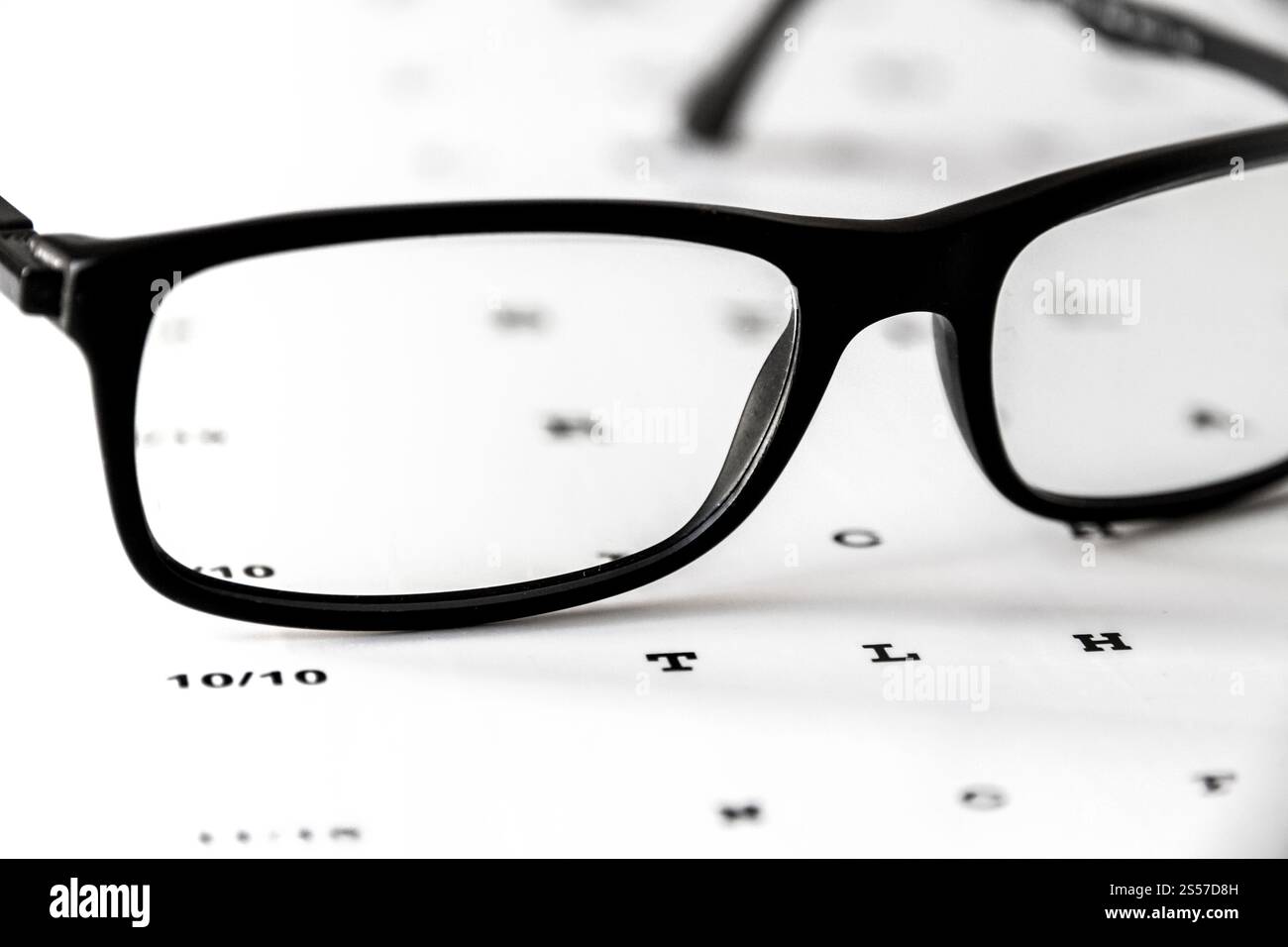 Glasses on eye chart. Optical device background. Glasses on eye chart ...