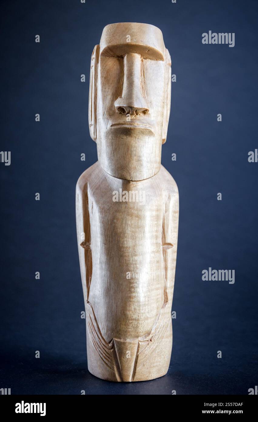 Traditional wooden statue of a moai from Easter Island. Dark background ...