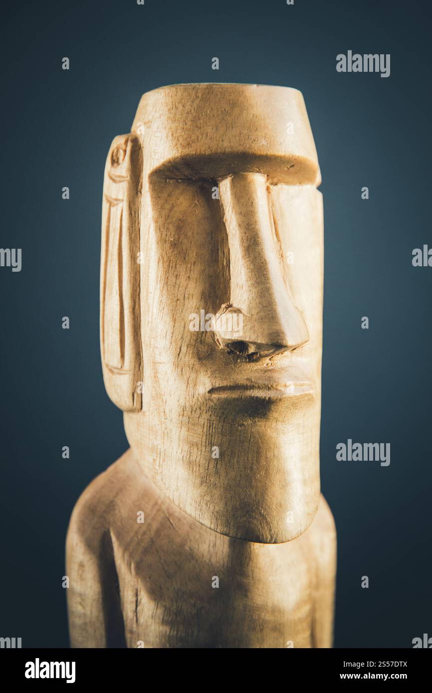 Traditional wooden statue of a moai from Easter Island. Dark background ...
