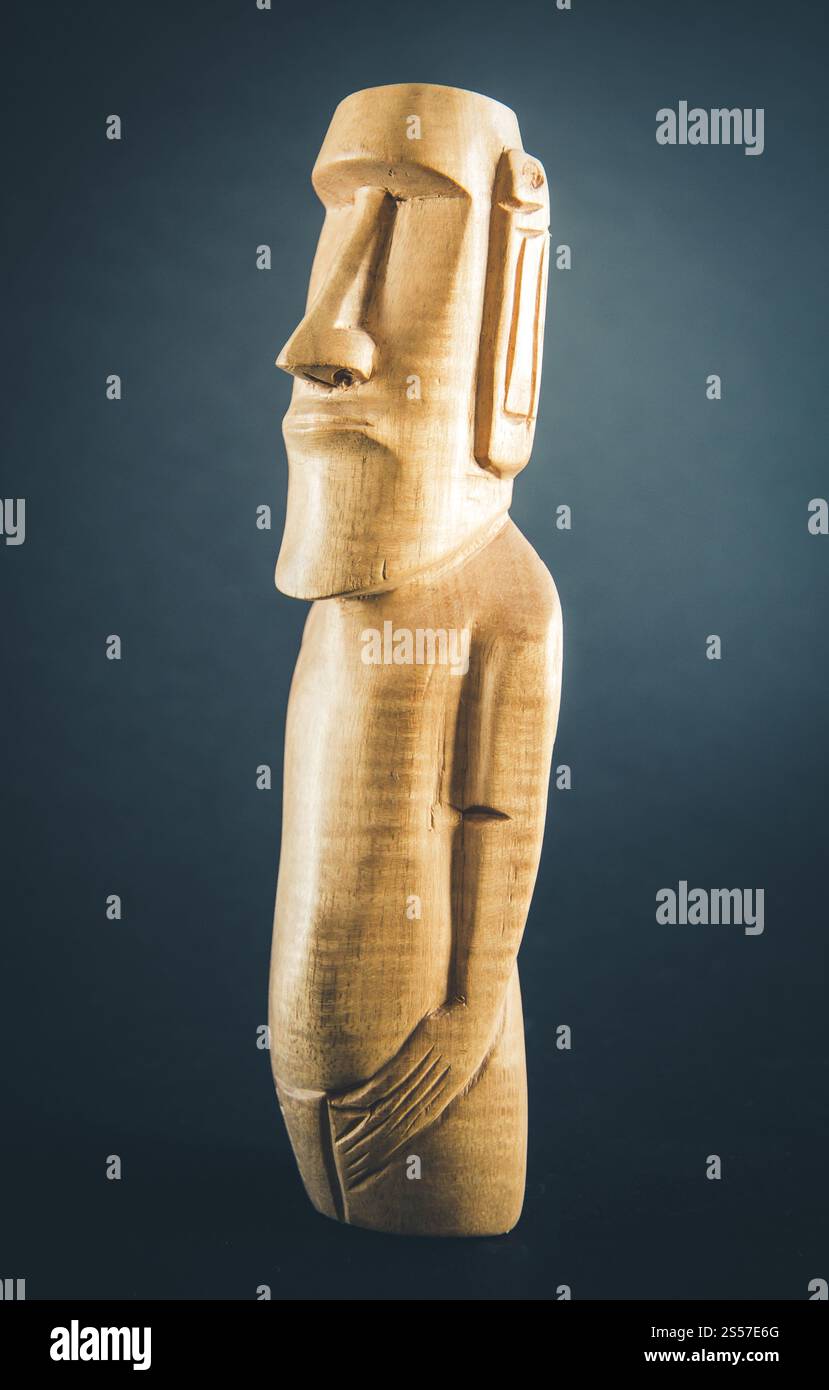 Traditional wooden statue of a moai from Easter Island. Dark background ...