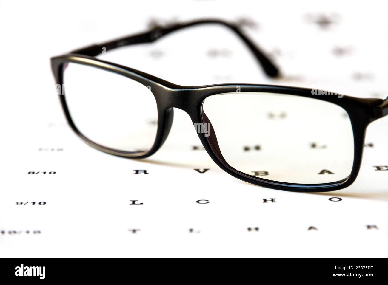 Glasses on eye chart. Optical device background. Glasses on eye chart ...