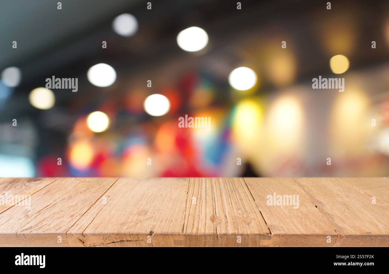 Wood table top in front of abstract blurred background. Empty wooden ...