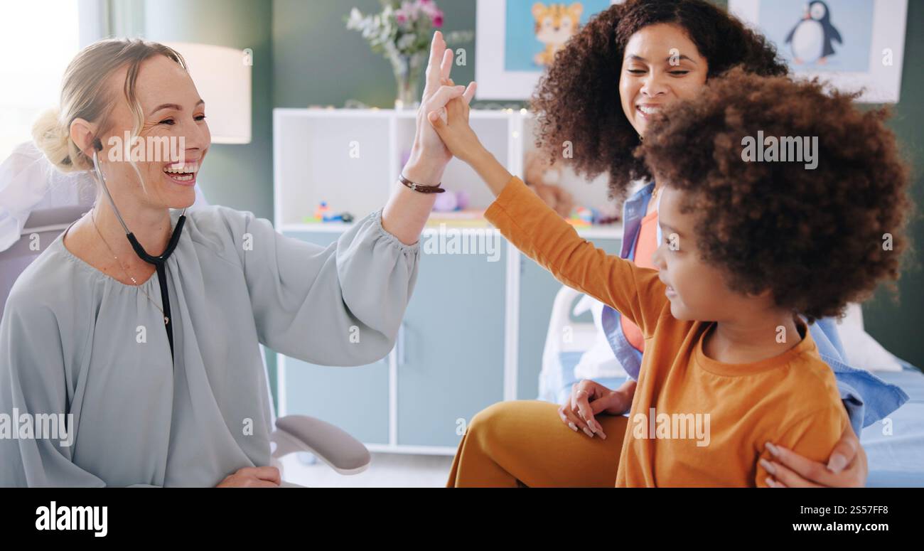 Doctor, child and high five for assessment, test results and hospital ...