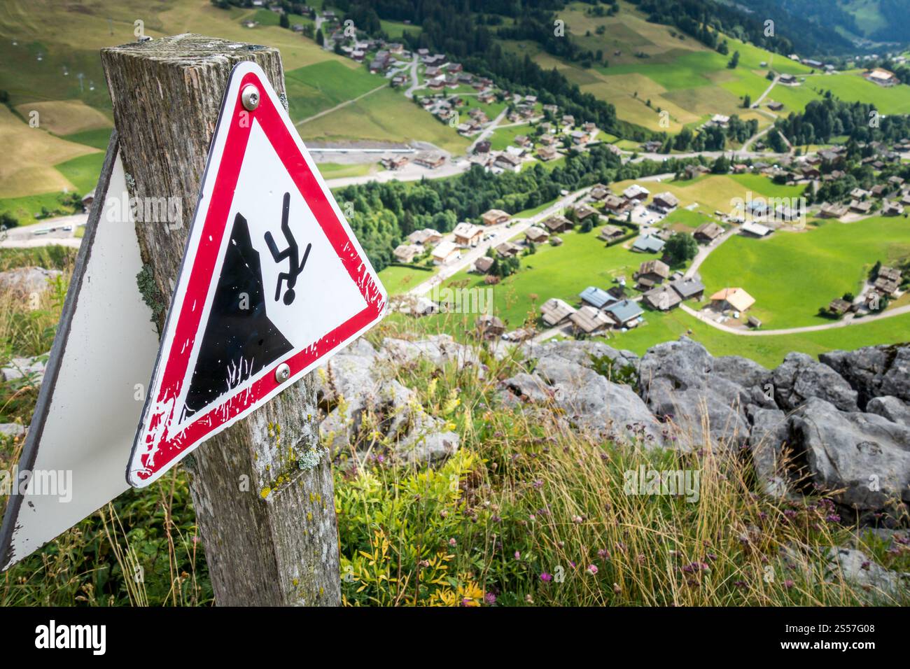 Fall danger warning sign near a high cliff. Fall danger warning sign ...