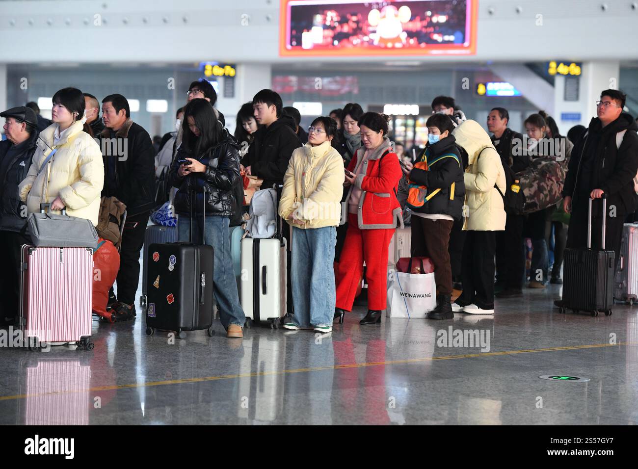 FUYANG, CHINA - JANUARY 14,2025 - Passengers line up at the waiting ...