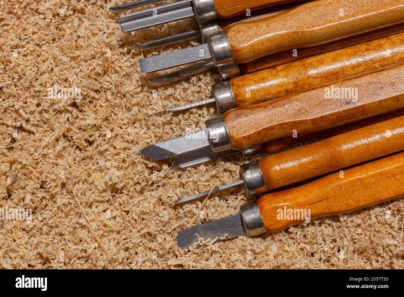 Set of precision wood chisels on a sawdust background backdrop ...