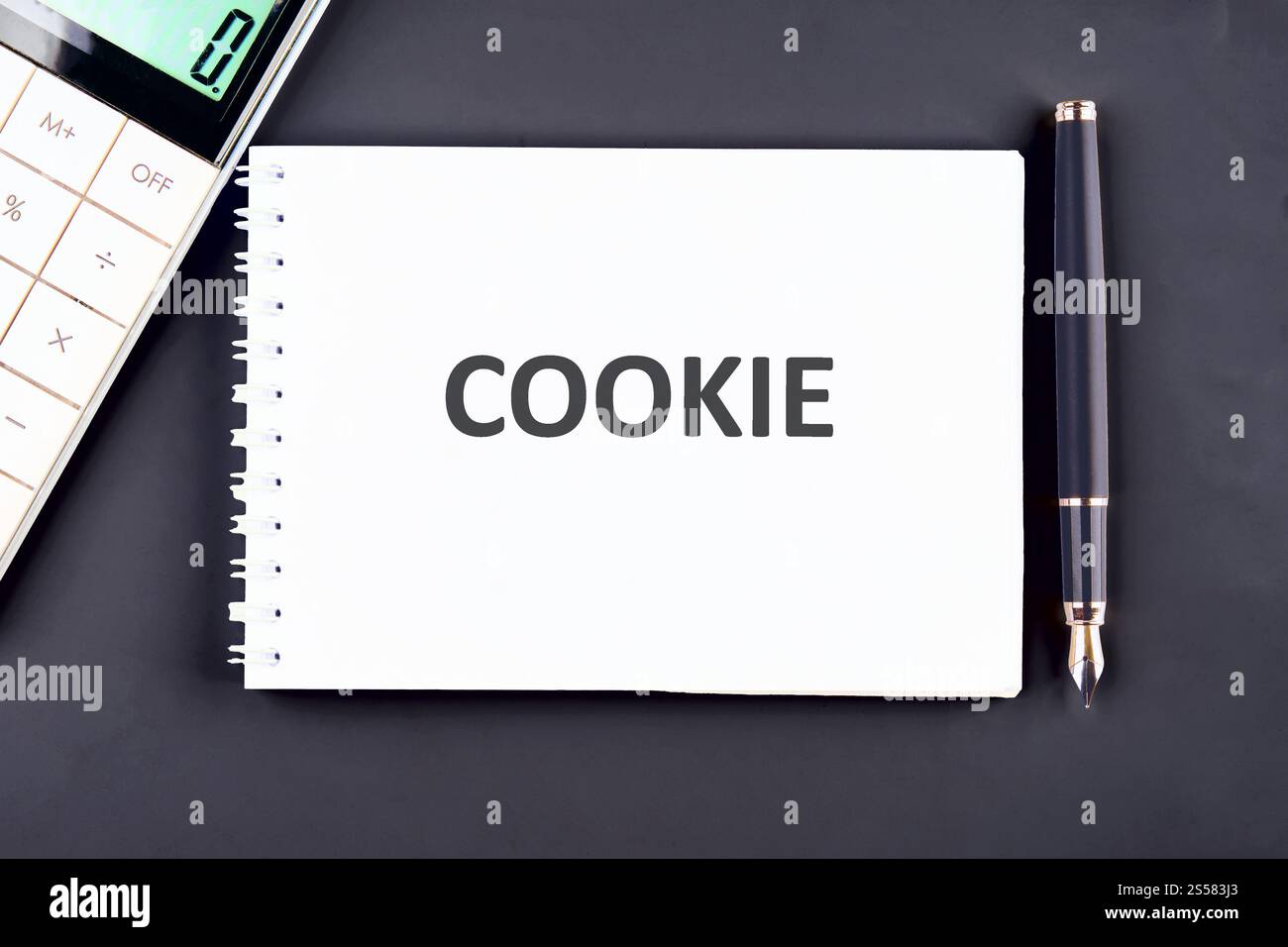 A notepad features the word cookie in bold letters, positioned beside a ...